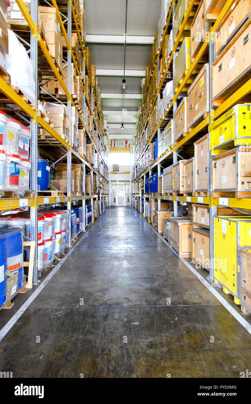 Corridor with big shelves in distribution warehouse Stock Photo - Alamy