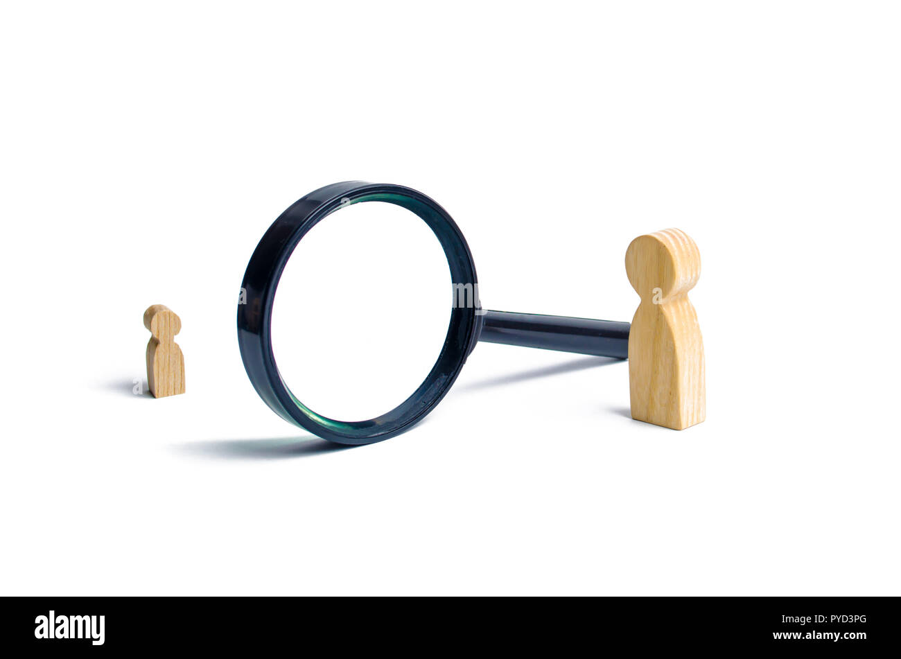 A wooden figure of a woman and a child stands near the magnifying glass ...