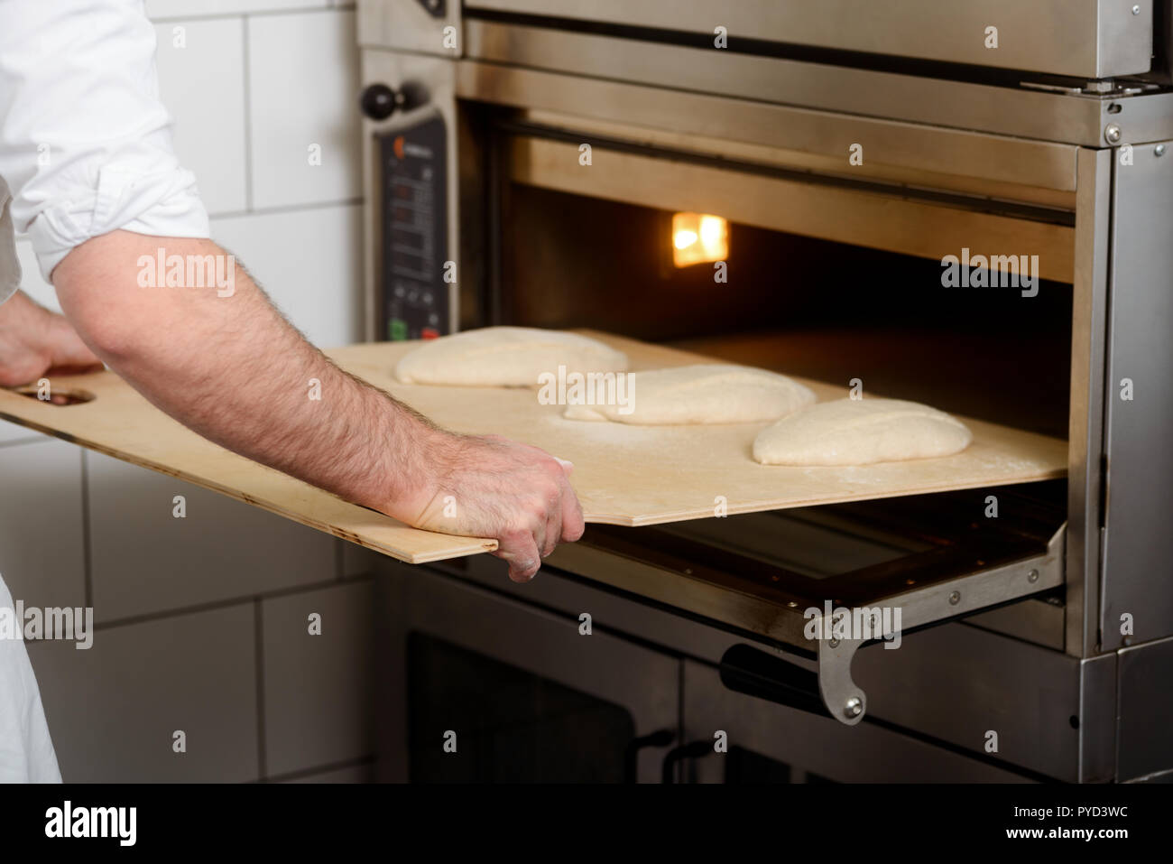 Loading bread into oven hi-res stock photography and images - Alamy