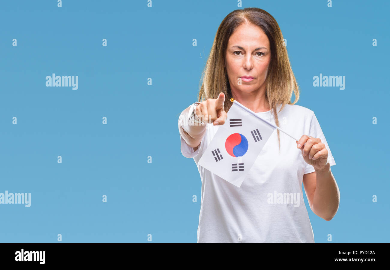 Middle age hispanic woman holding flag of South Korea over isolated ...