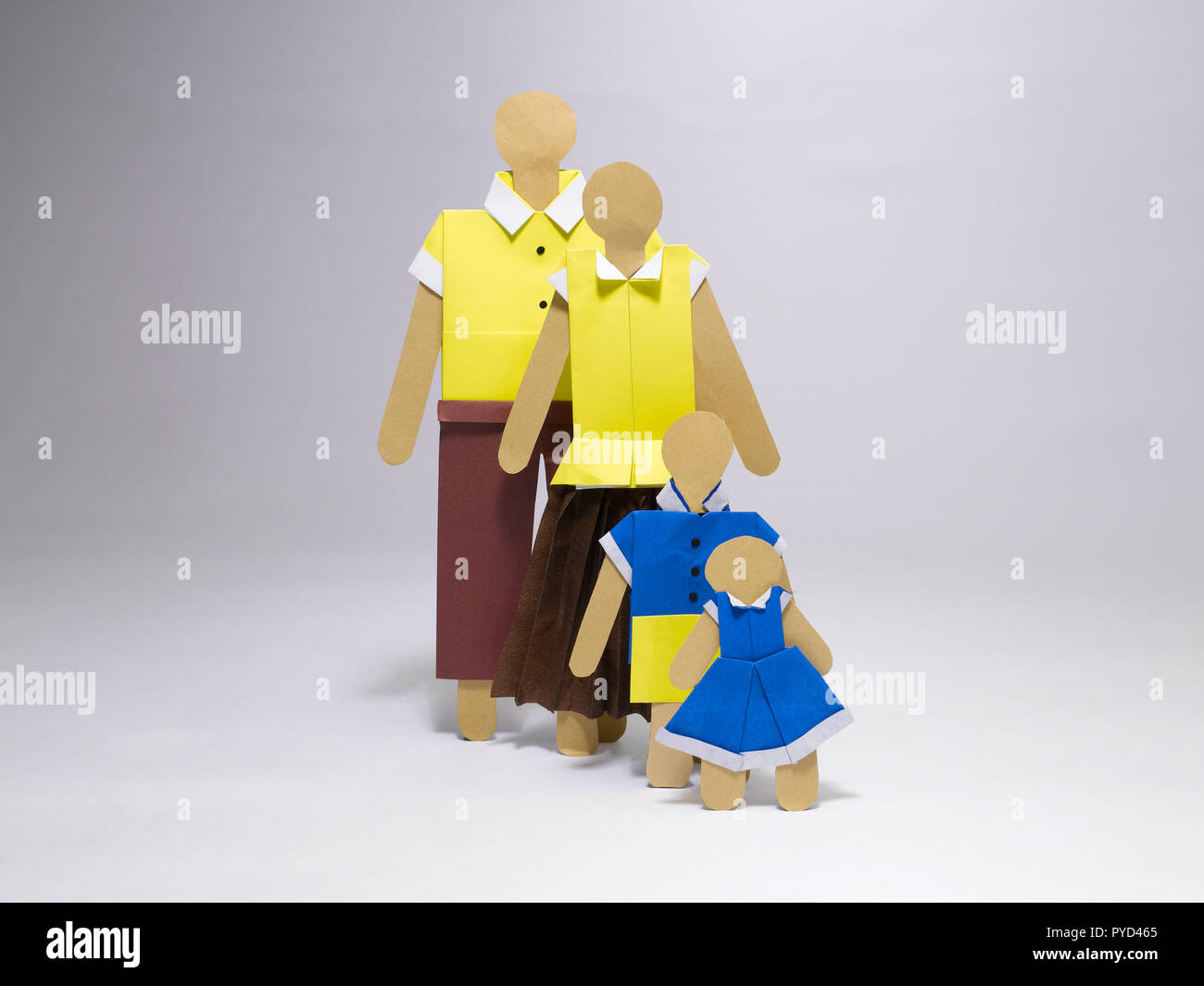 FAMILY OF FOUR USING THE ART OF ORIGAMI Stock Photo - Alamy