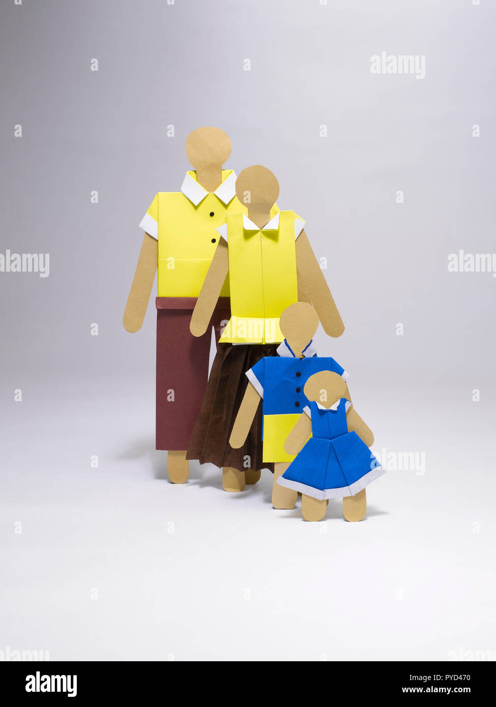 FAMILY OF FOUR USING THE ART OF ORIGAMI Stock Photo - Alamy