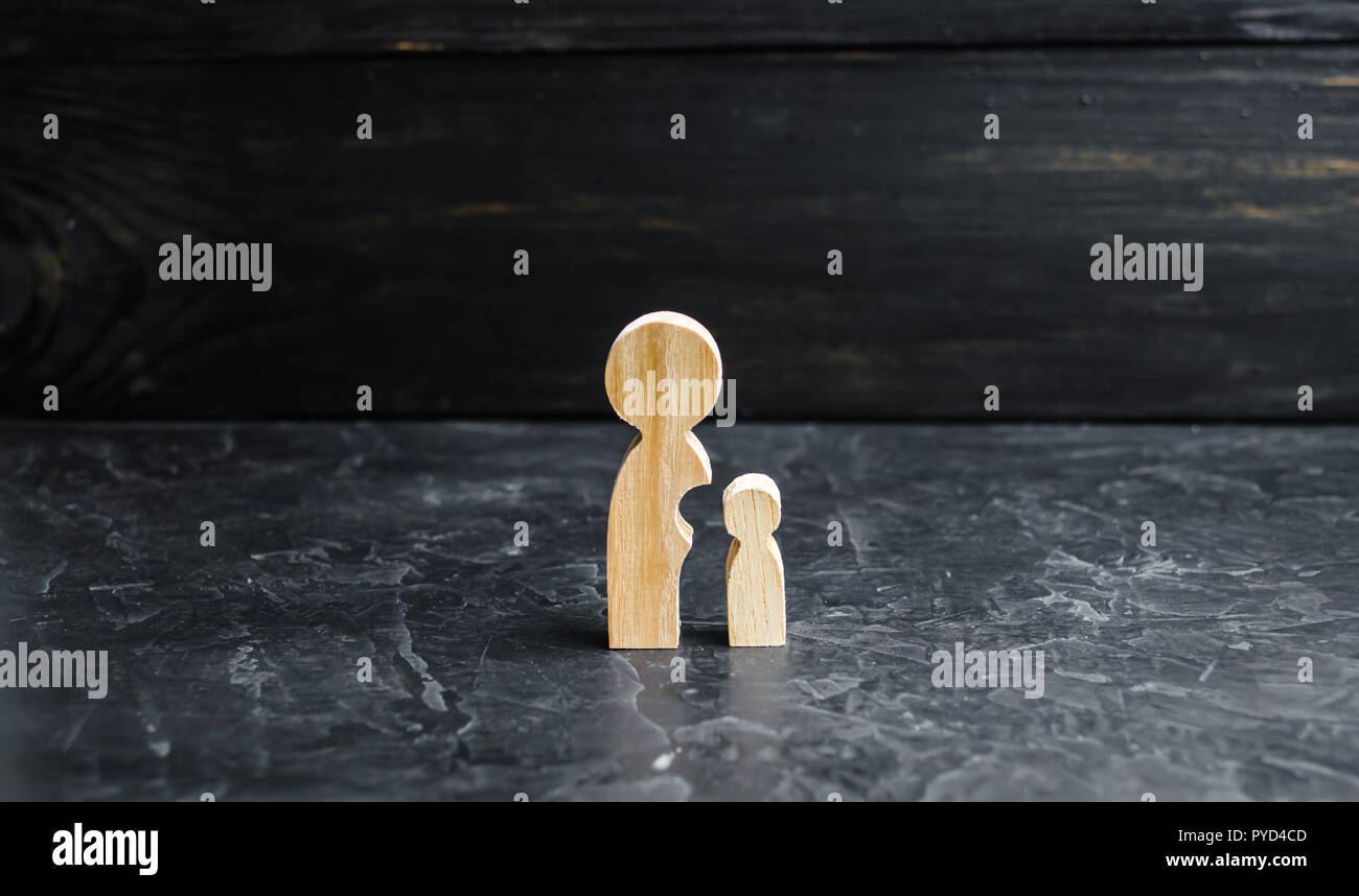 Wooden figures of mother and child. The baby is separated from the ...