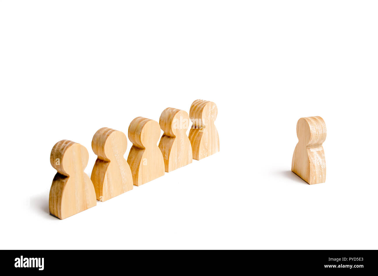 Wooden figures of people stand in the formation and listen to their ...