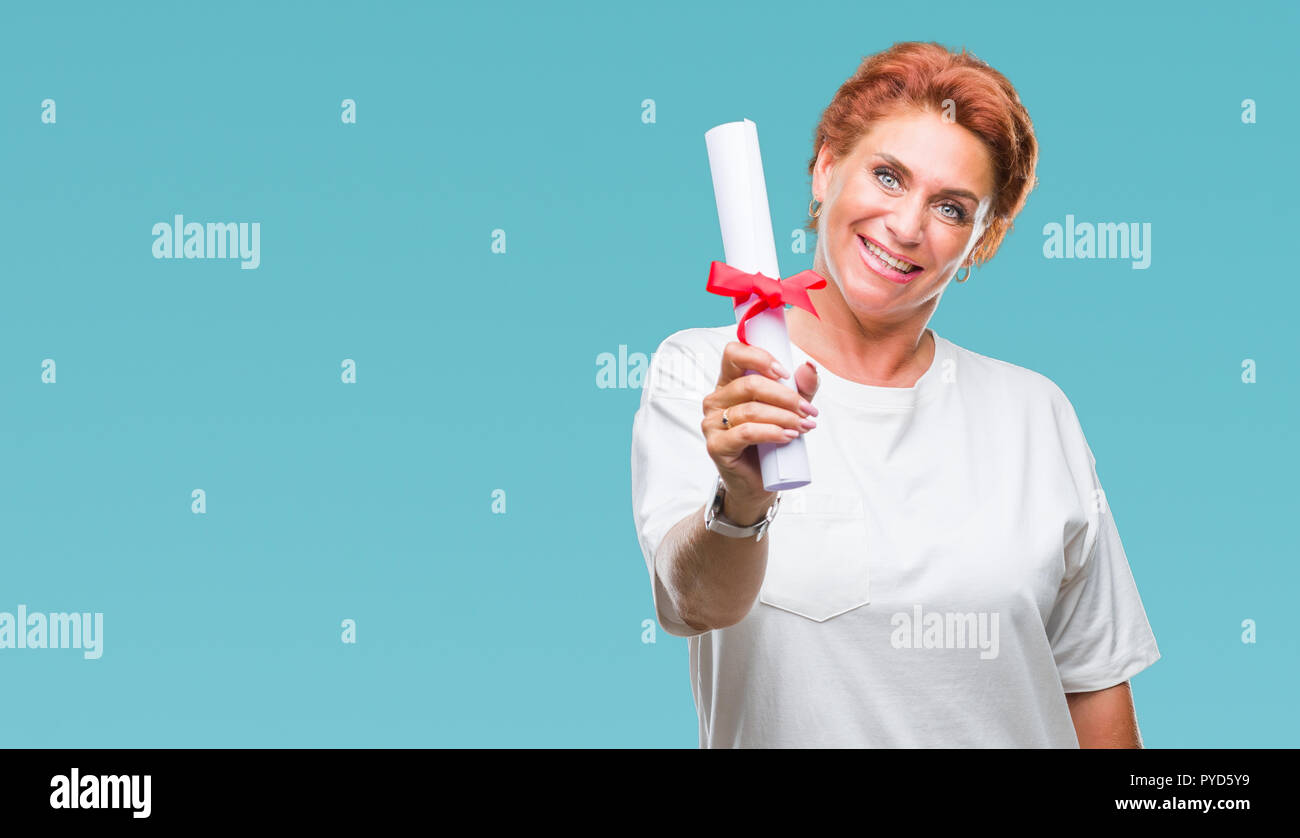 Senior caucasian woman holding degree certificate over isolated ...