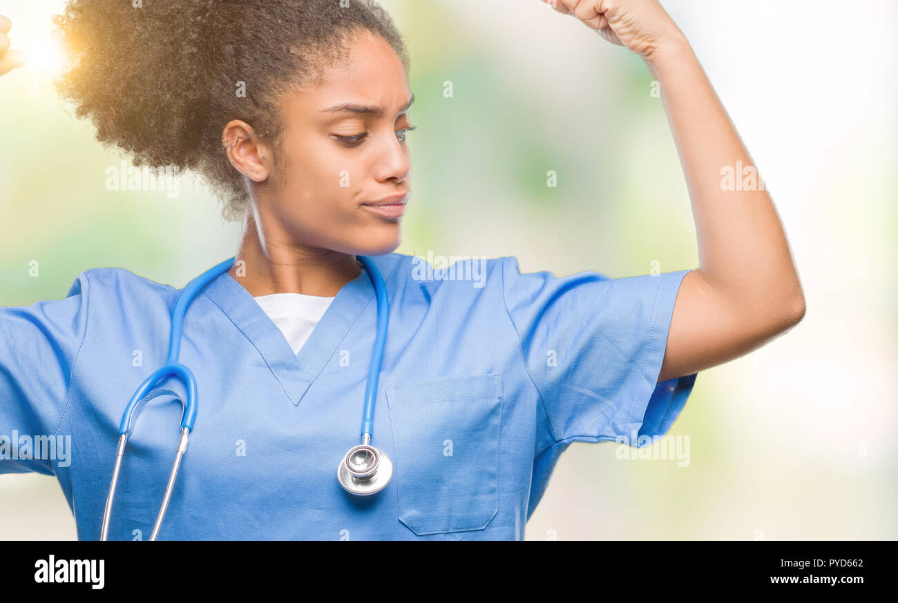Young afro american doctor woman over isolated background showing arms ...