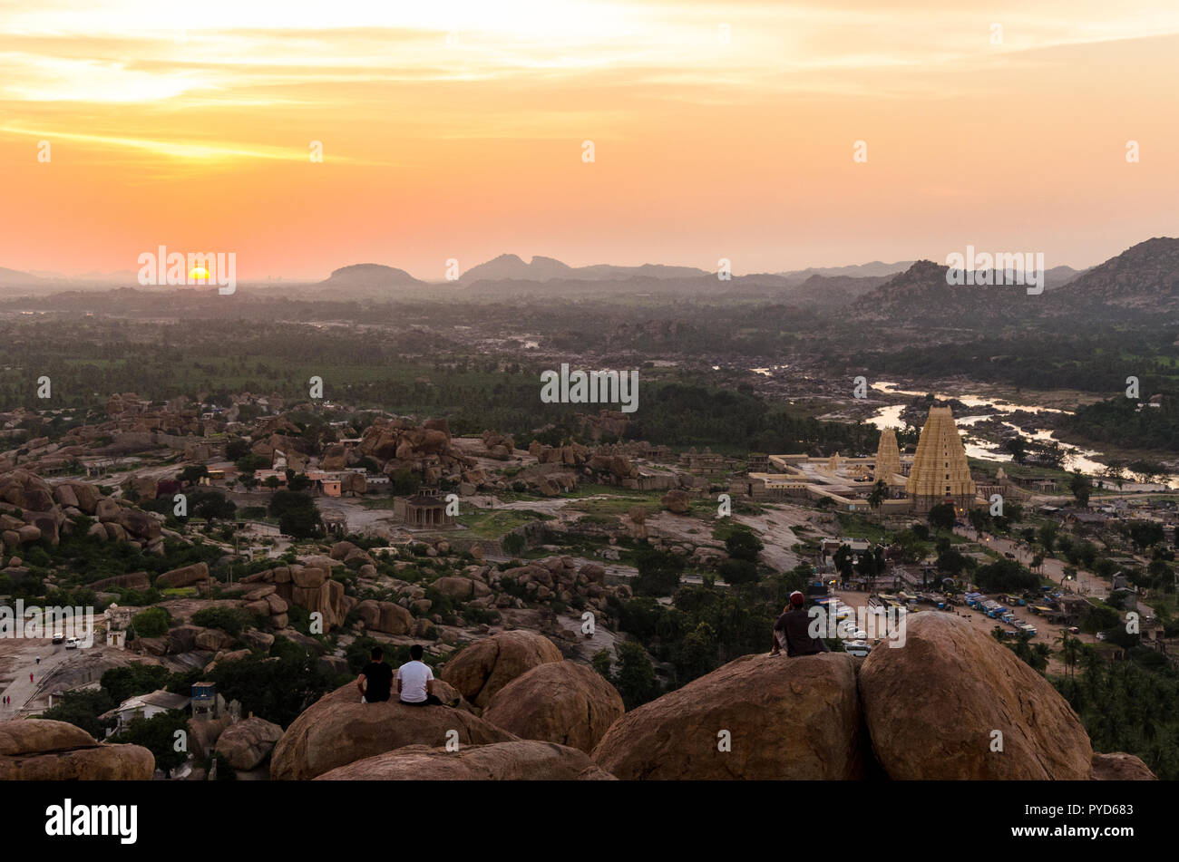 Scenic sunset over landscape dotted with giant boulders and ruins ...
