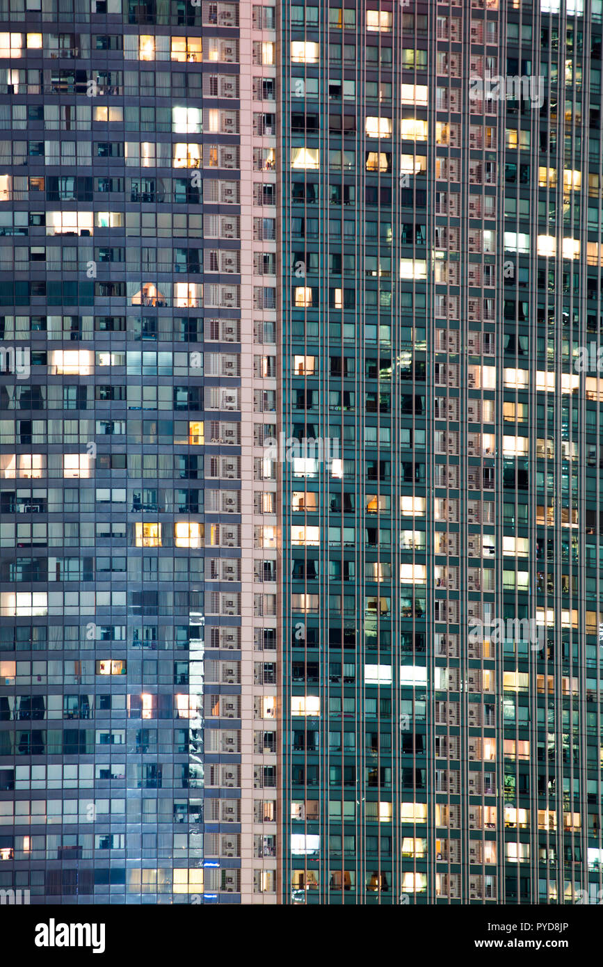 Glass facade of modern city high rise, buildings show lighting using by ...