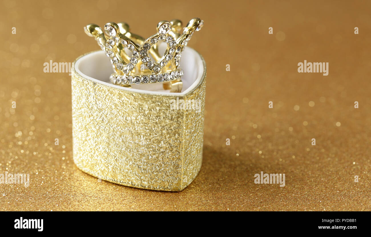 precious crown on a gold background Stock Photo - Alamy
