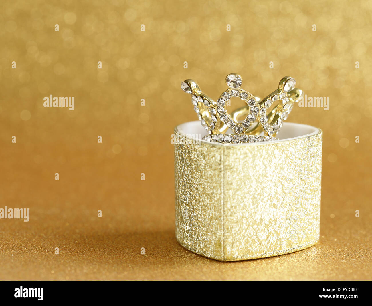 precious crown on a gold background Stock Photo - Alamy