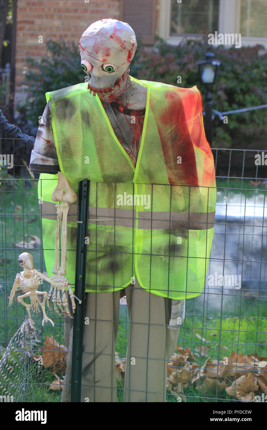 Scary and caged zombies trying to get out of a fenced in area as ...