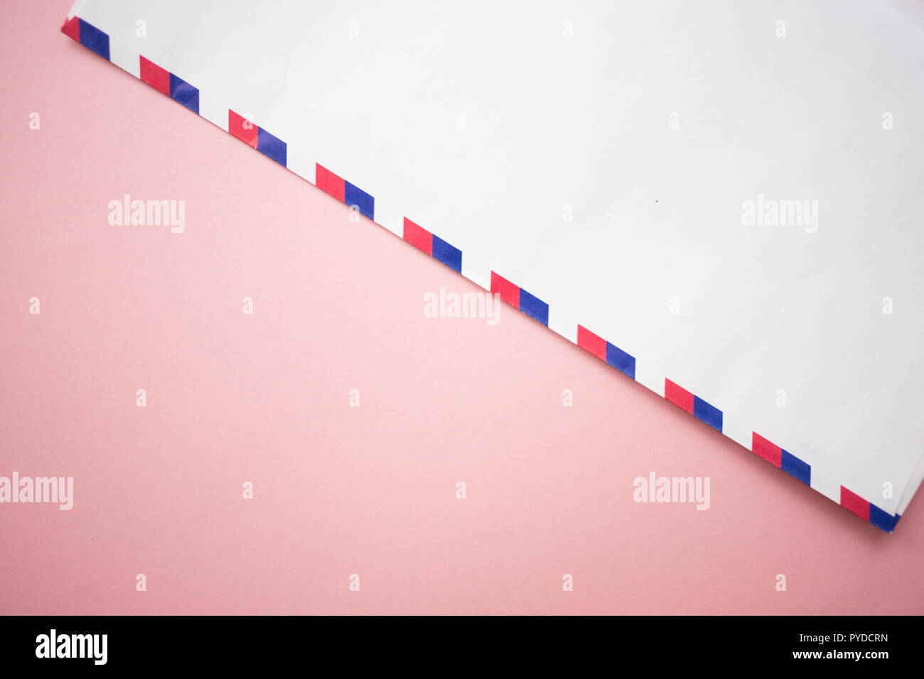 air mail envelope letter on pink background Stock Photo - Alamy