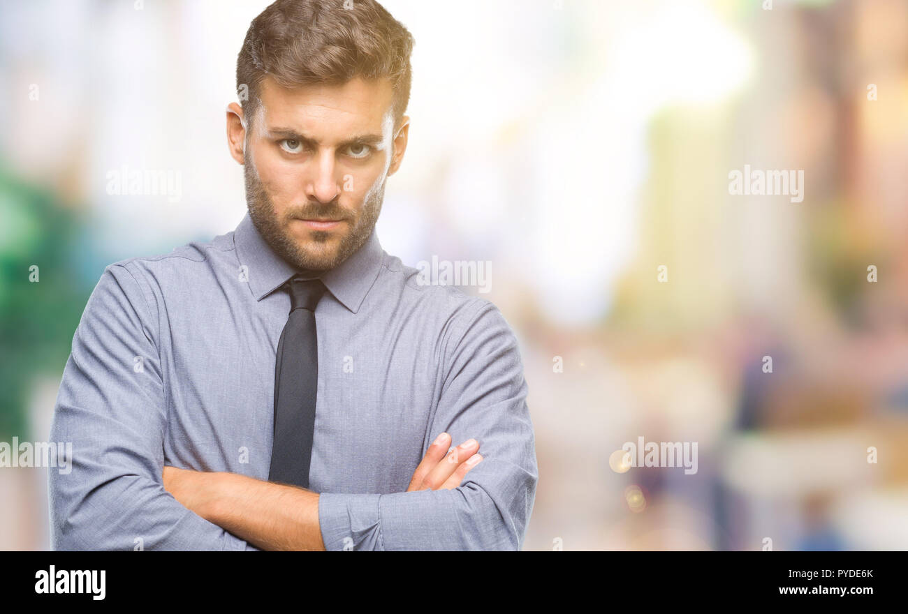 Young handsome business man over isolated background skeptic and ...