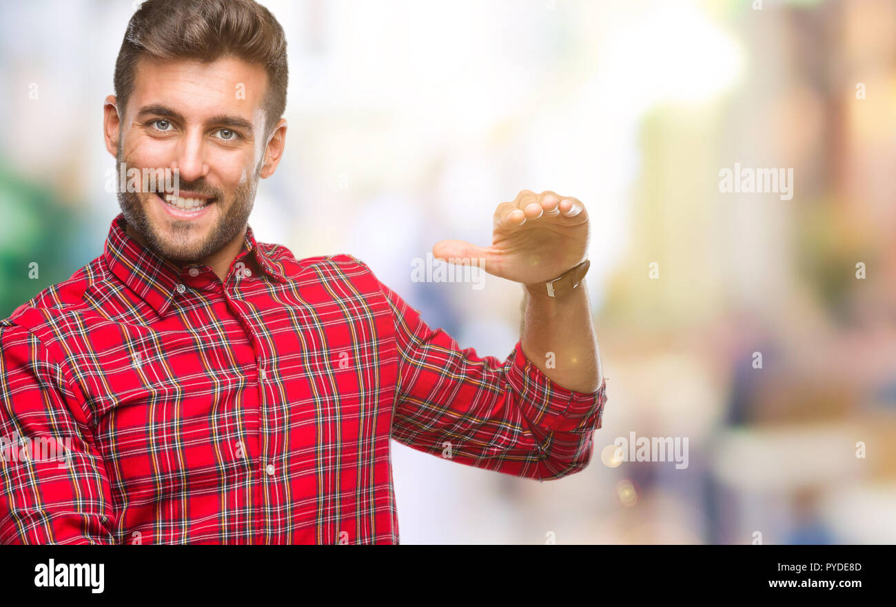 Young handsome man over isolated background gesturing with hands ...