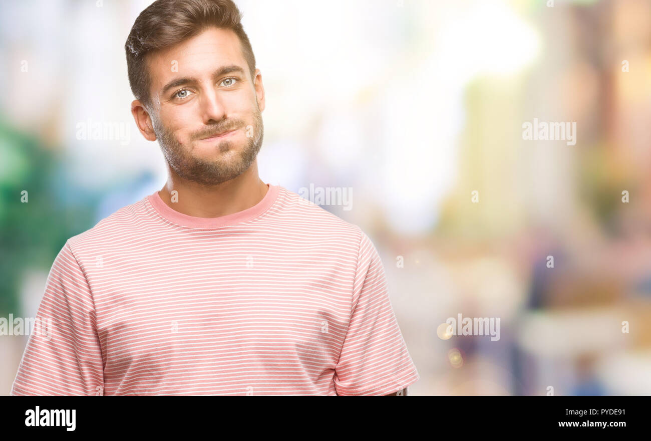 Young handsome man over isolated background puffing cheeks with funny ...