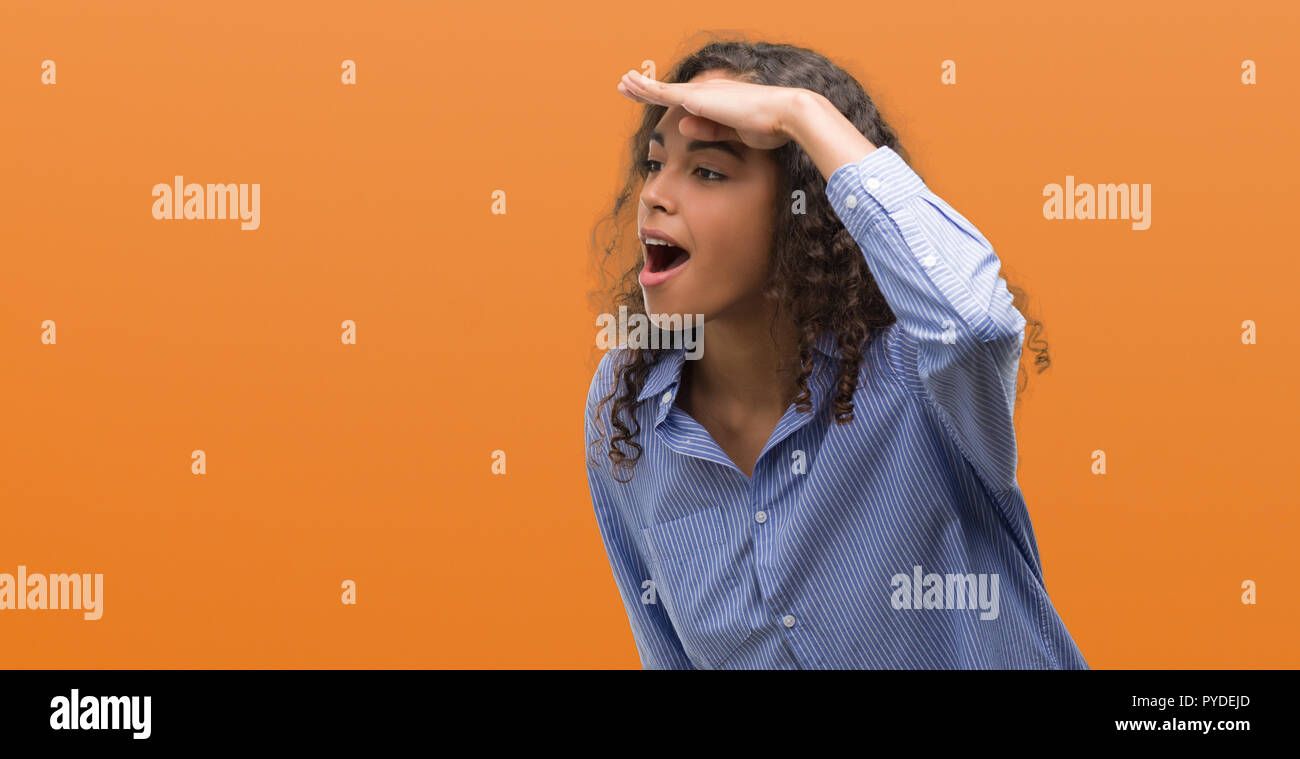 Young hispanic business woman very happy and smiling looking far away ...