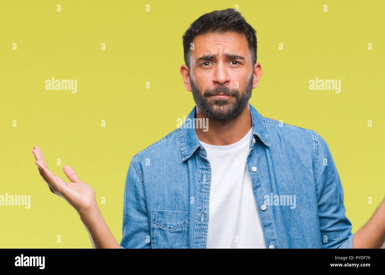 Adult hispanic man over isolated background clueless and confused ...