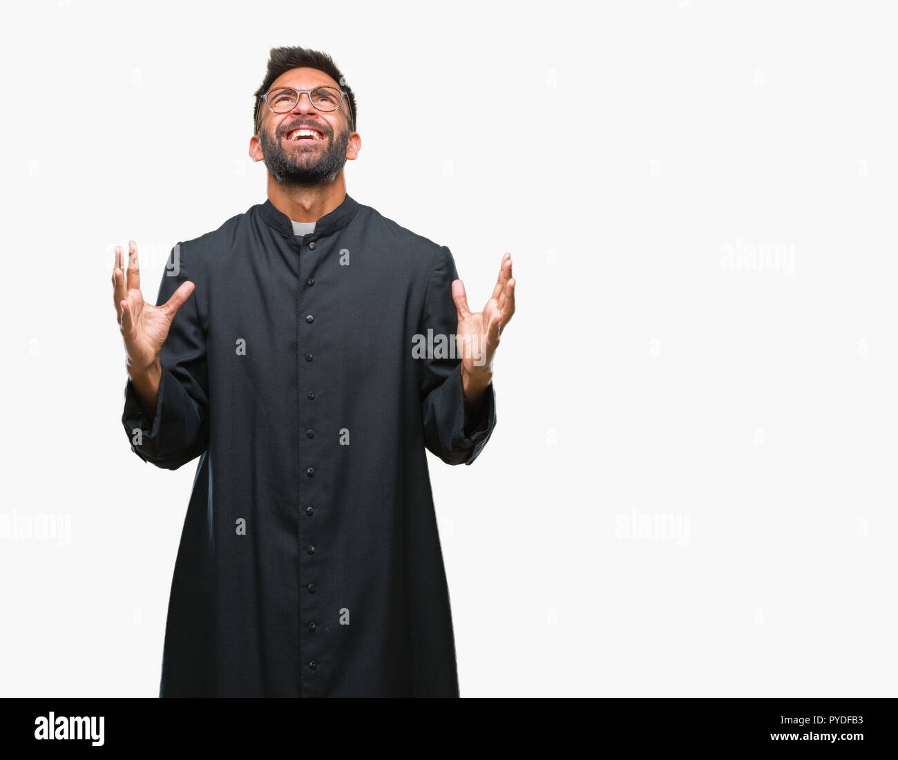 Adult hispanic catholic priest man over isolated background crazy and ...