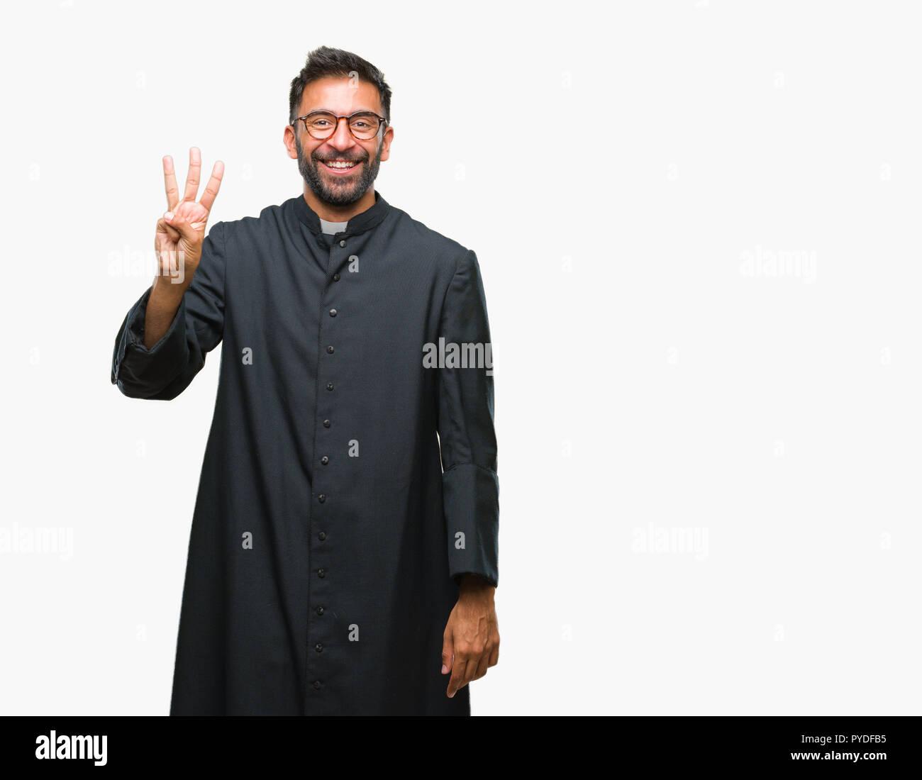 Adult hispanic catholic priest man over isolated background showing and ...
