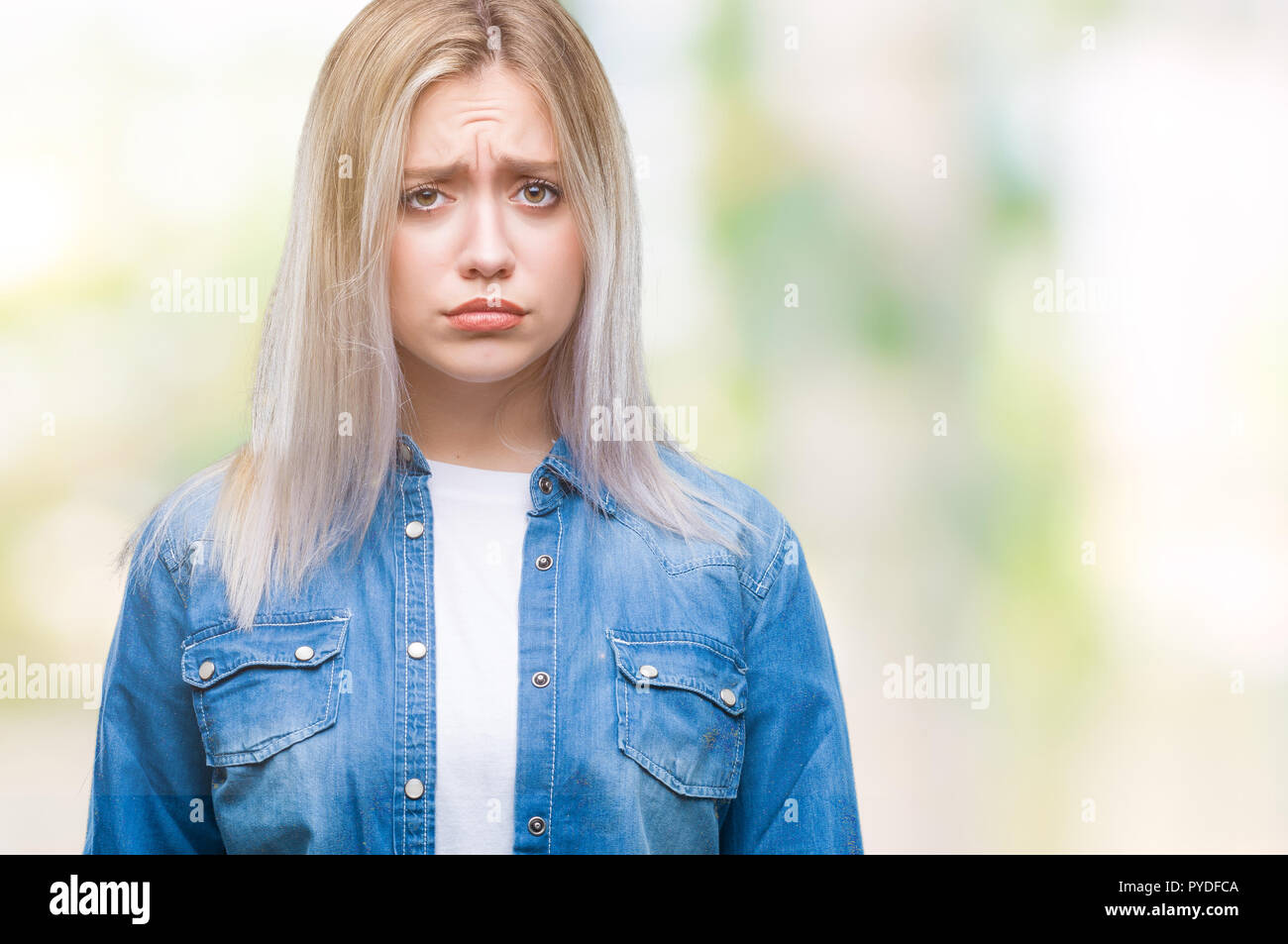 Young blonde woman over isolated background depressed and worry for ...