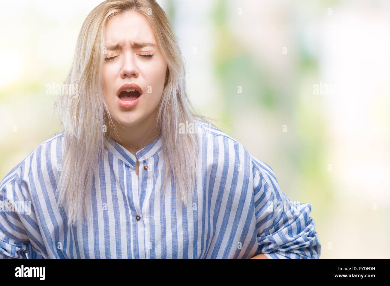 Young blonde woman over isolated background with hand on stomach ...