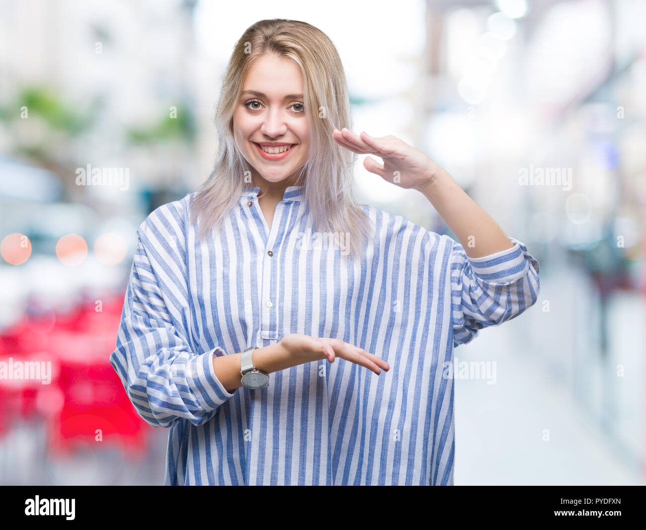 Young blonde woman over isolated background gesturing with hands ...