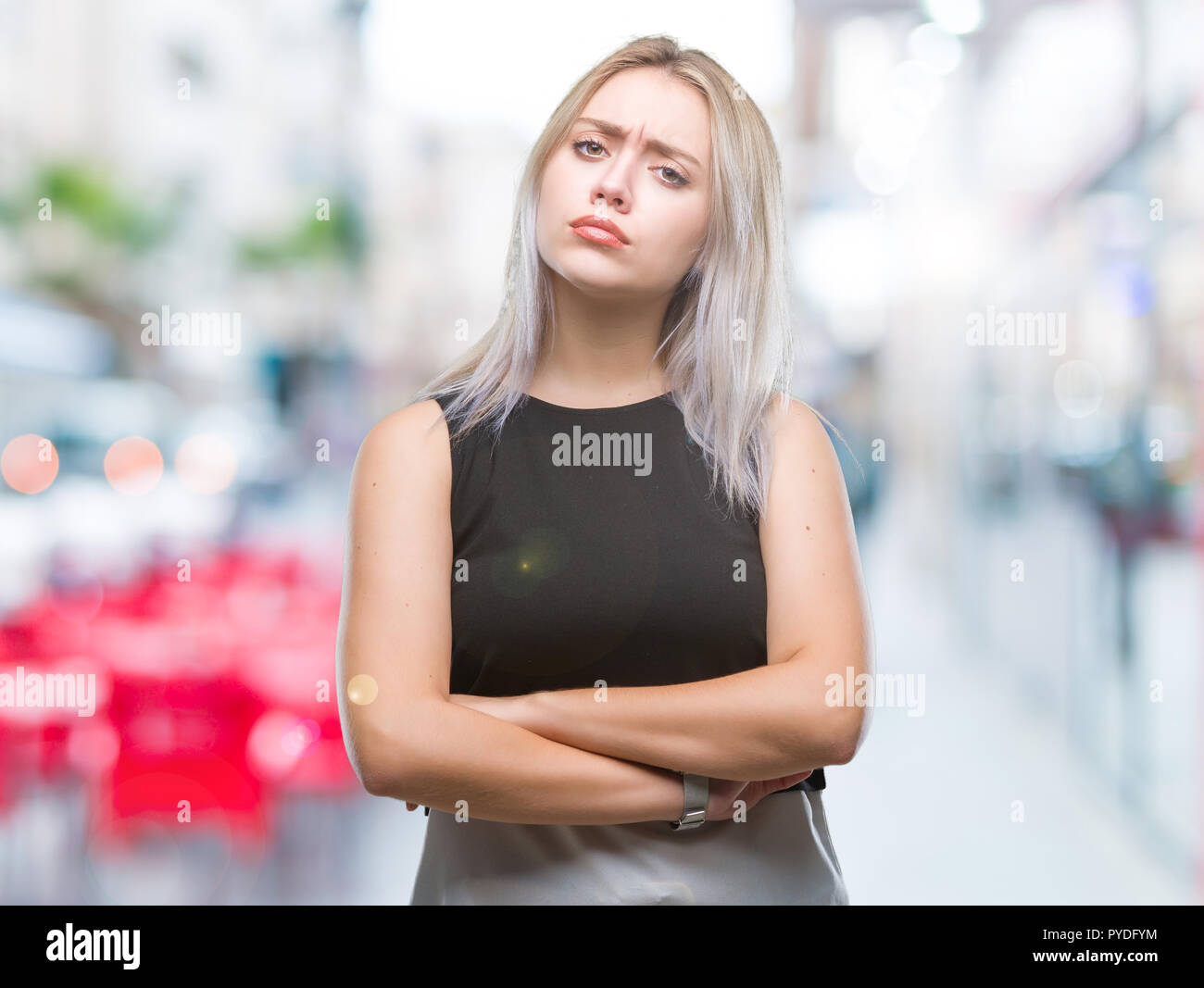 Young blonde woman over isolated background skeptic and nervous ...