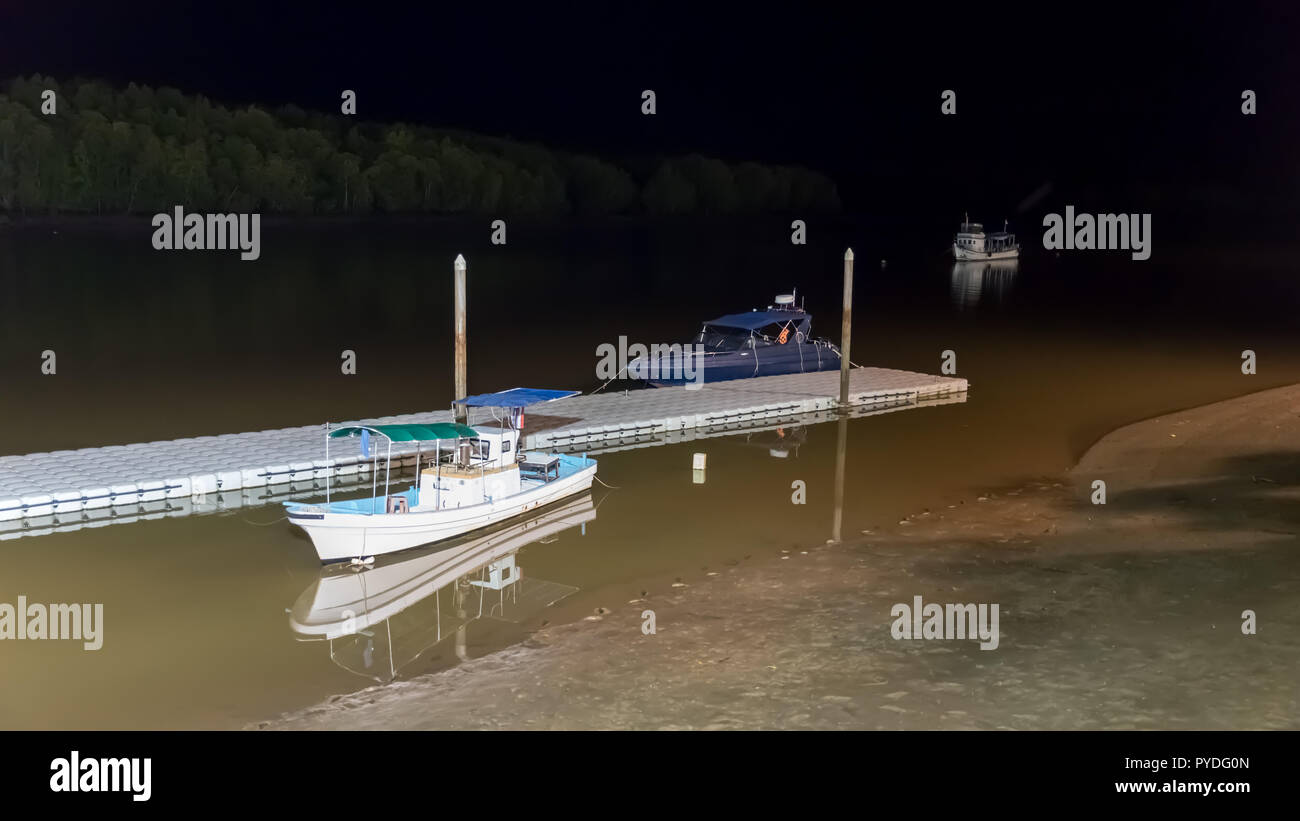 Three boats at dock and anchored at night Stock Photo - Alamy