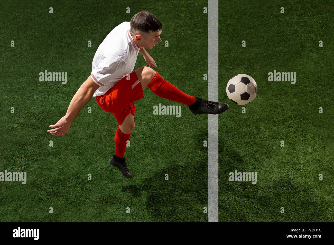 Football player tackling for ball over green grass background ...