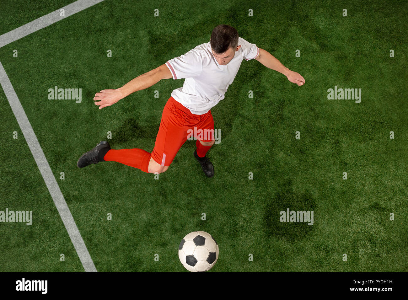 Football player tackling for ball over green grass background ...