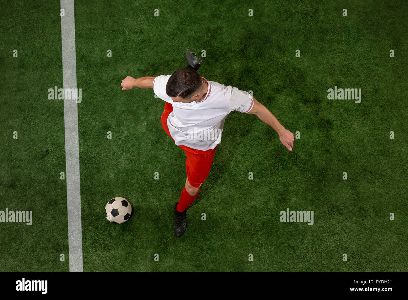 Football player tackling for ball over green grass background ...
