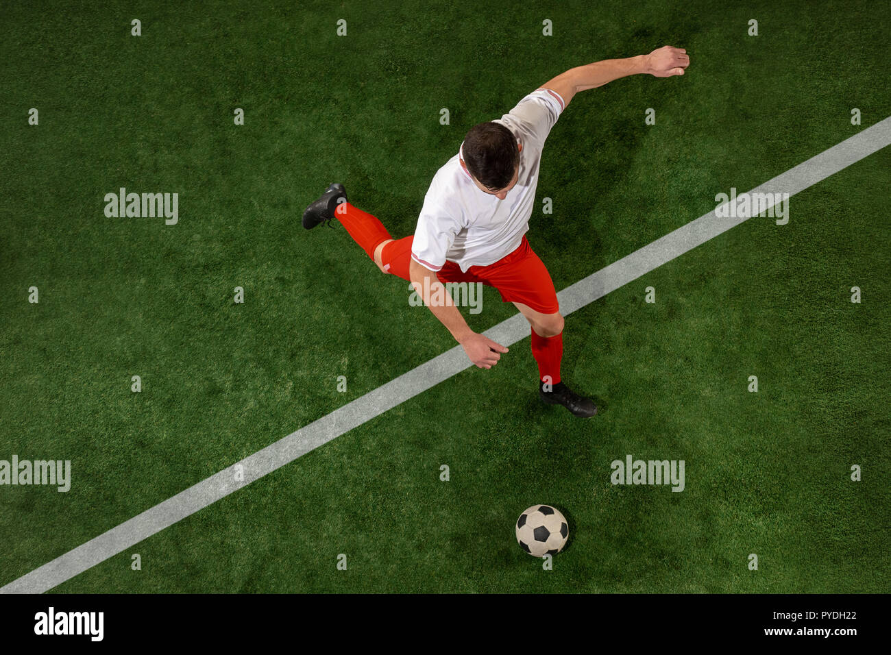 Football player tackling for ball over green grass background ...