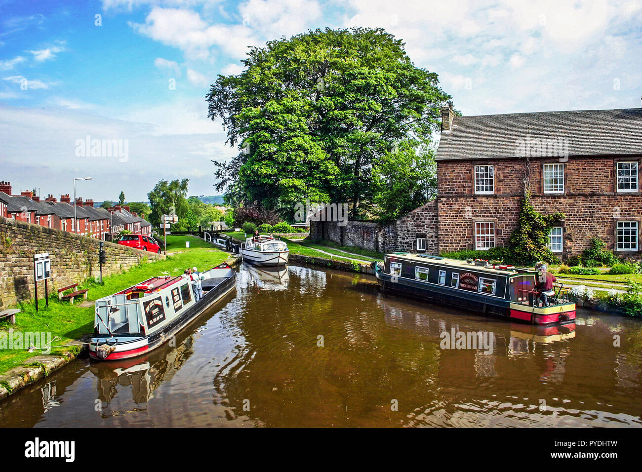 Barges and pleasure craft heading and at top locks on canal at Marple ...
