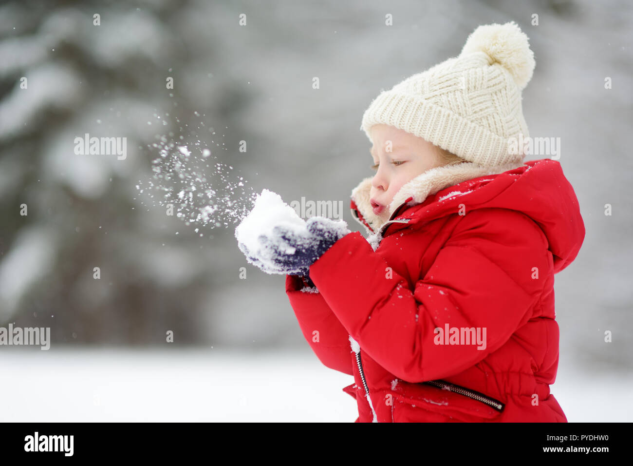 Adorable little girl having fun in beautiful winter park. Cute child ...