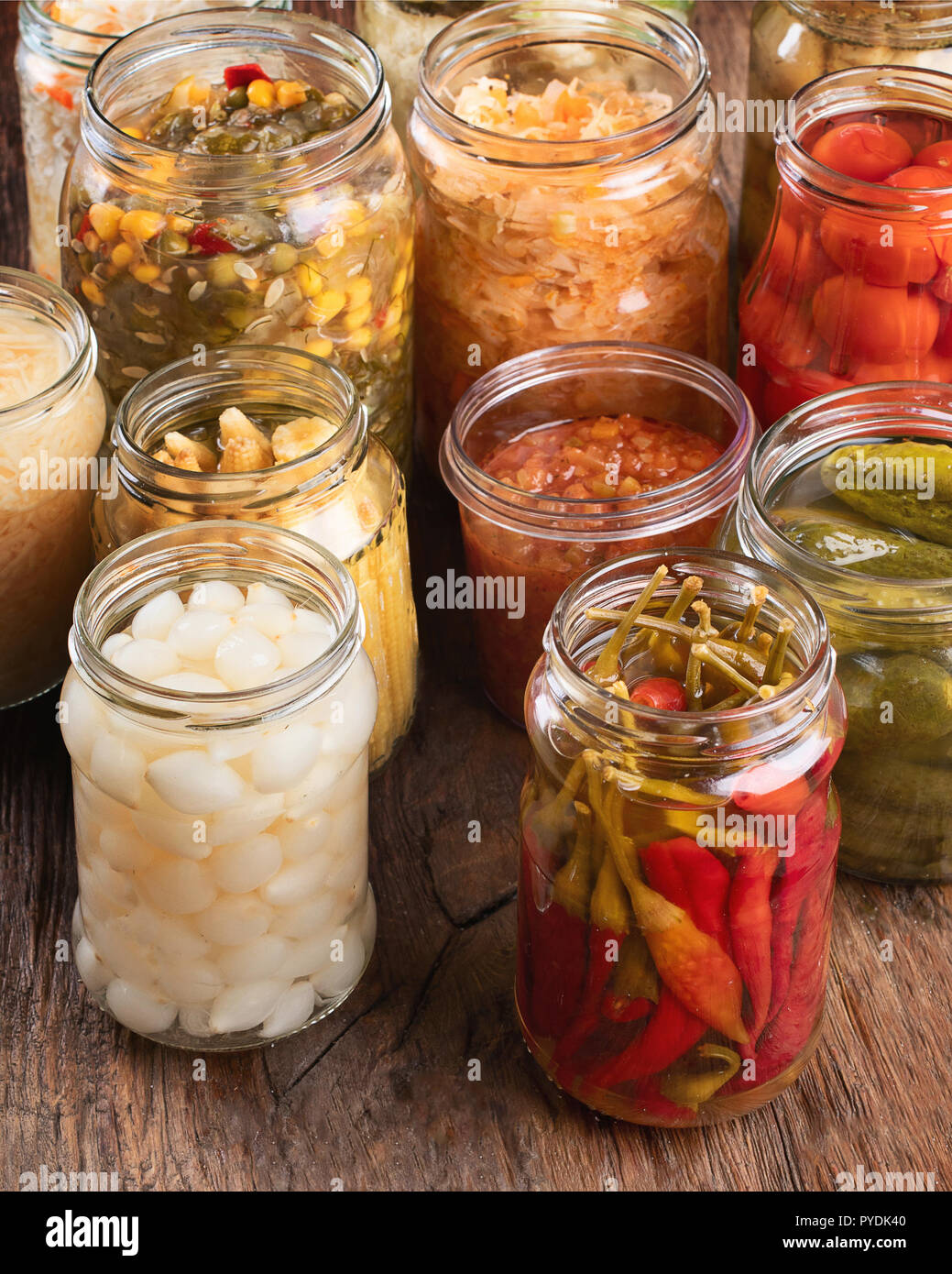 Different Fermented preserved vegetables in glass jars on a rustic ...