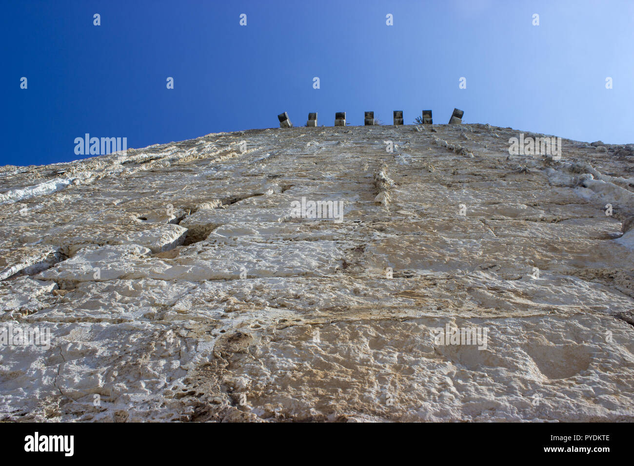 Detail of a stone wall. Bottom view. Blue sky Stock Photo - Alamy