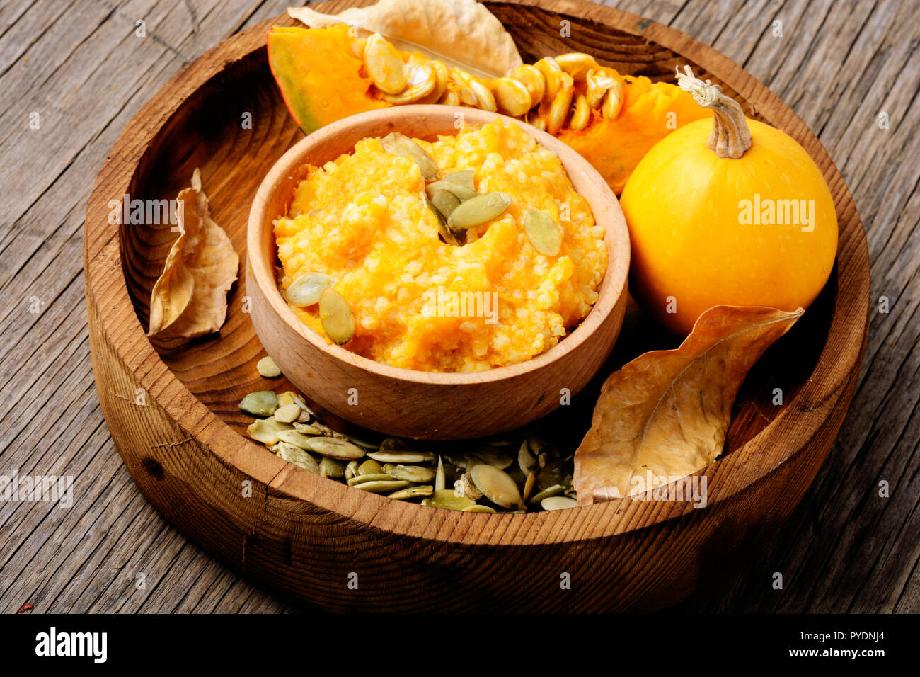 Homemade tasty porridge with orange pumpkin on rustic background Stock ...