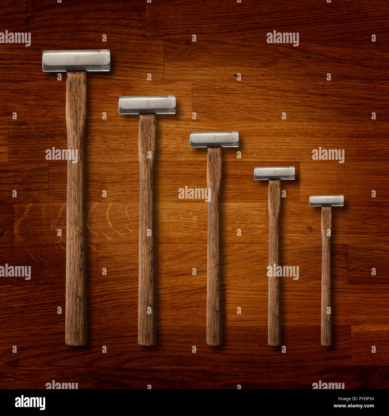 A selection of precision carpentry hammers on a wooden board, with room ...