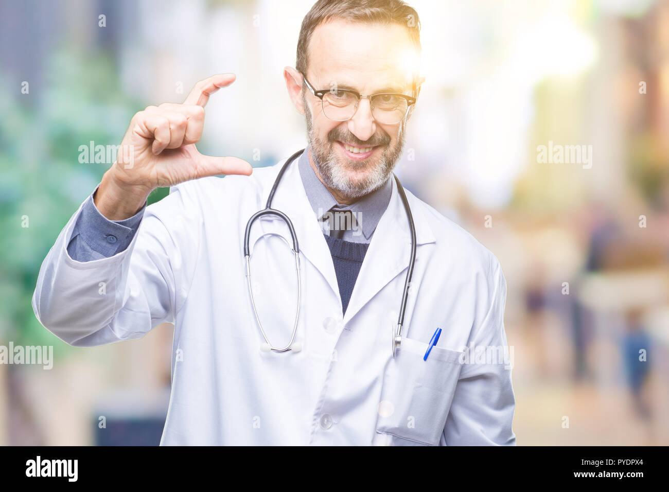 Middle age senior hoary doctor man wearing medical uniform isolated ...