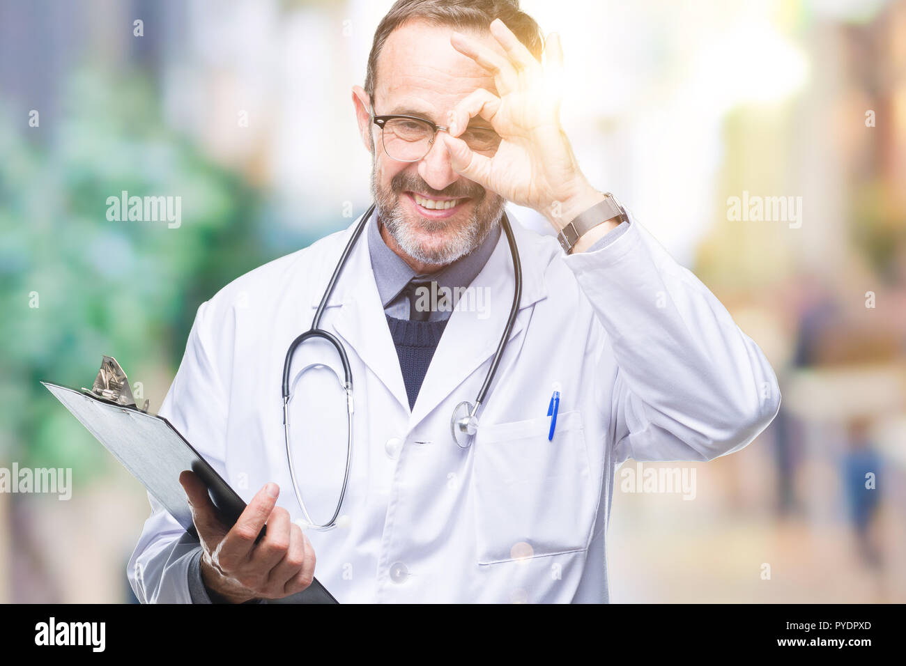 Middle age senior hoary doctor man holding clipboard over isolated ...