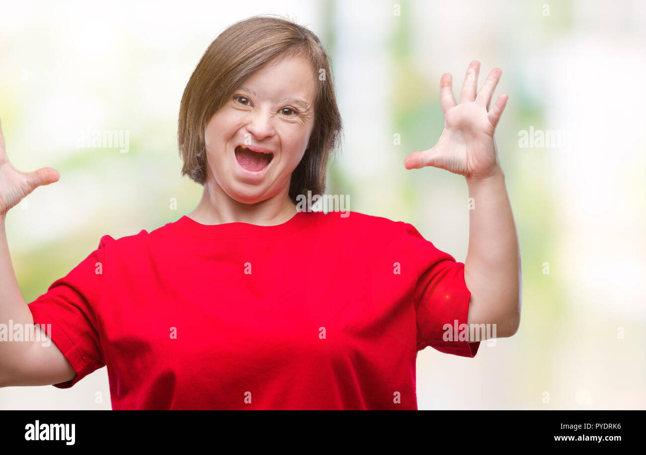 Young adult woman with down syndrome over isolated background crazy and ...