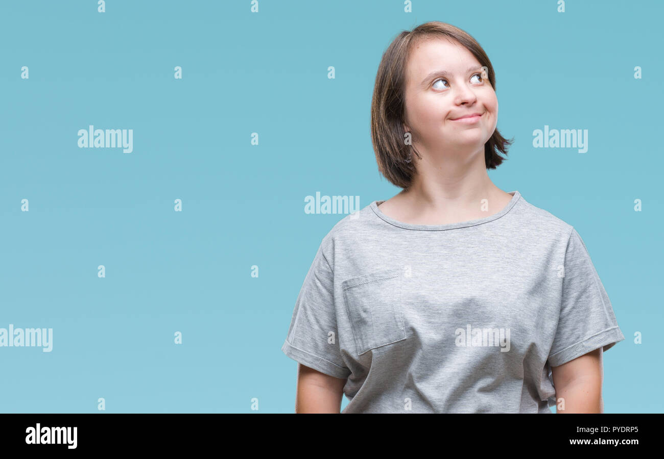 Young adult woman with down syndrome over isolated background smiling ...