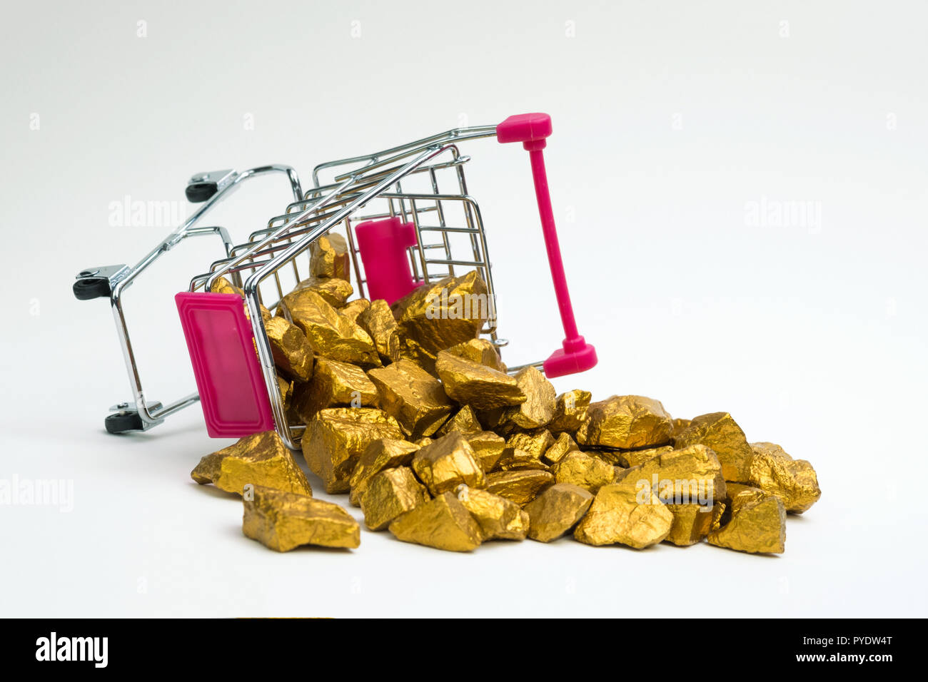 Pile of gold nuggets or gold ore in shopping cart or supermarket ...