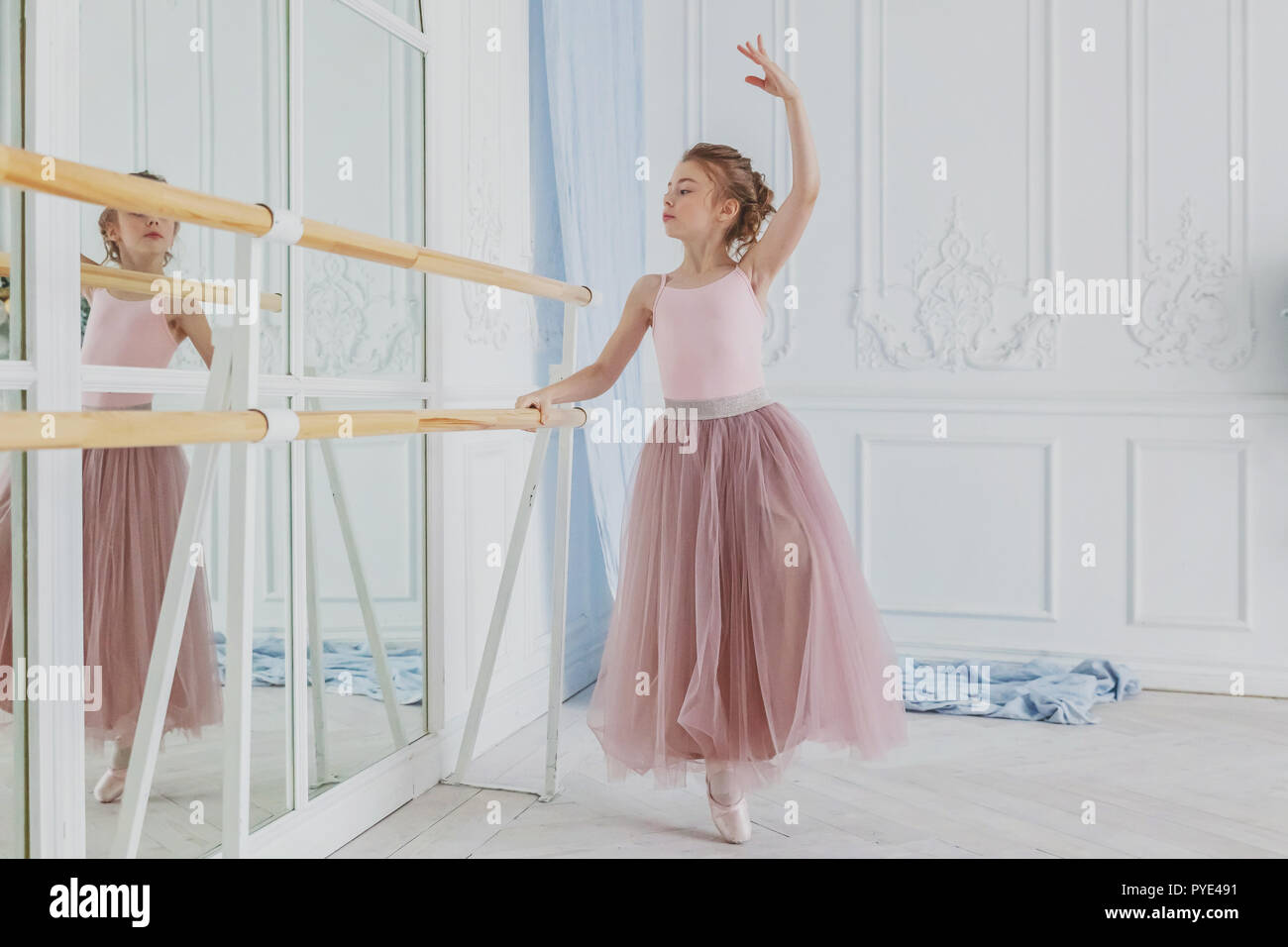 Young classical ballet dancer girl in dance class. Beautiful graceful ...
