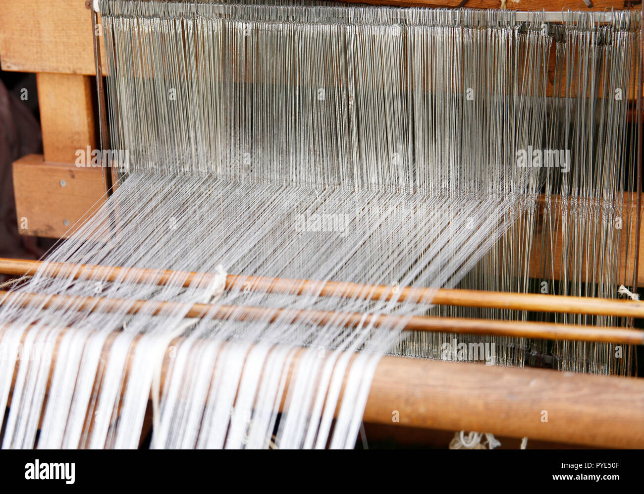 loom with white thread background Stock Photo - Alamy