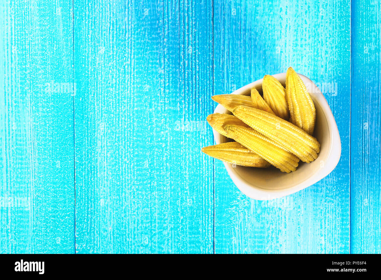 Baby sweetcorn or mini corn. It is typically the eaten whole cob ...