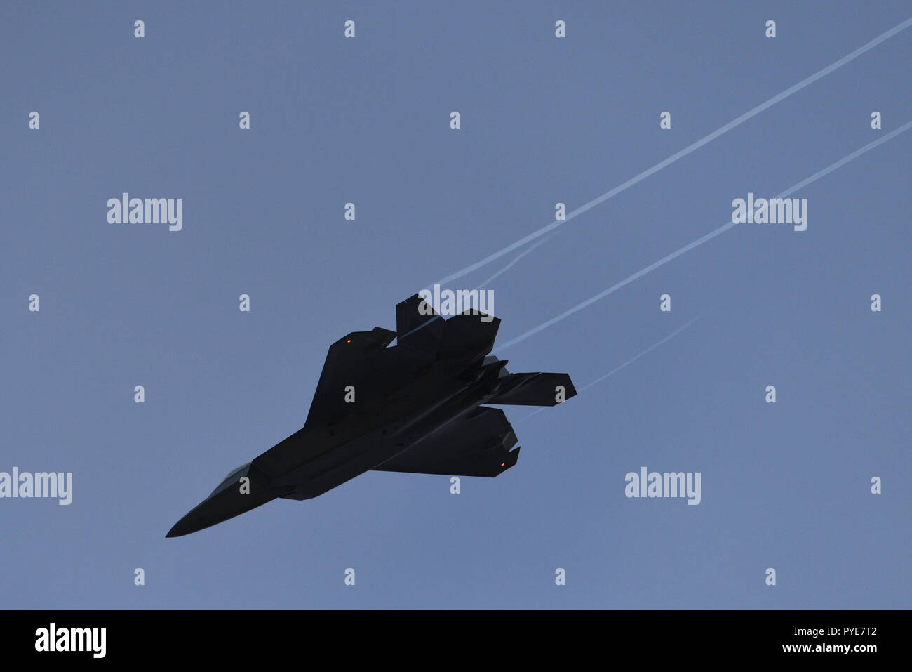 A U.S. Air Force F-22 Raptor flies over the runway at Joint Base ...