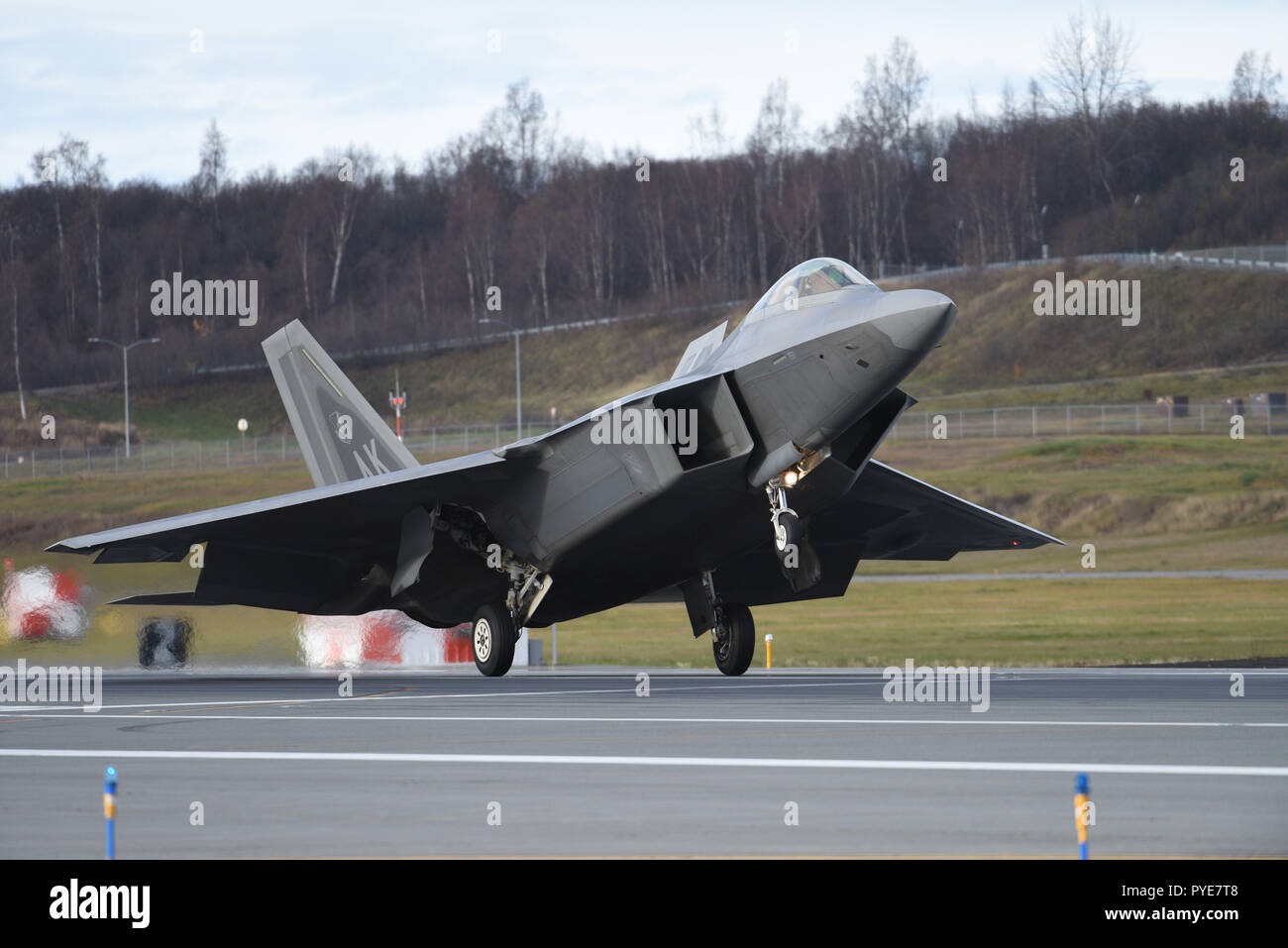 A U.S. Air Force F-22 Raptor touches down on the runway at Joint Base ...