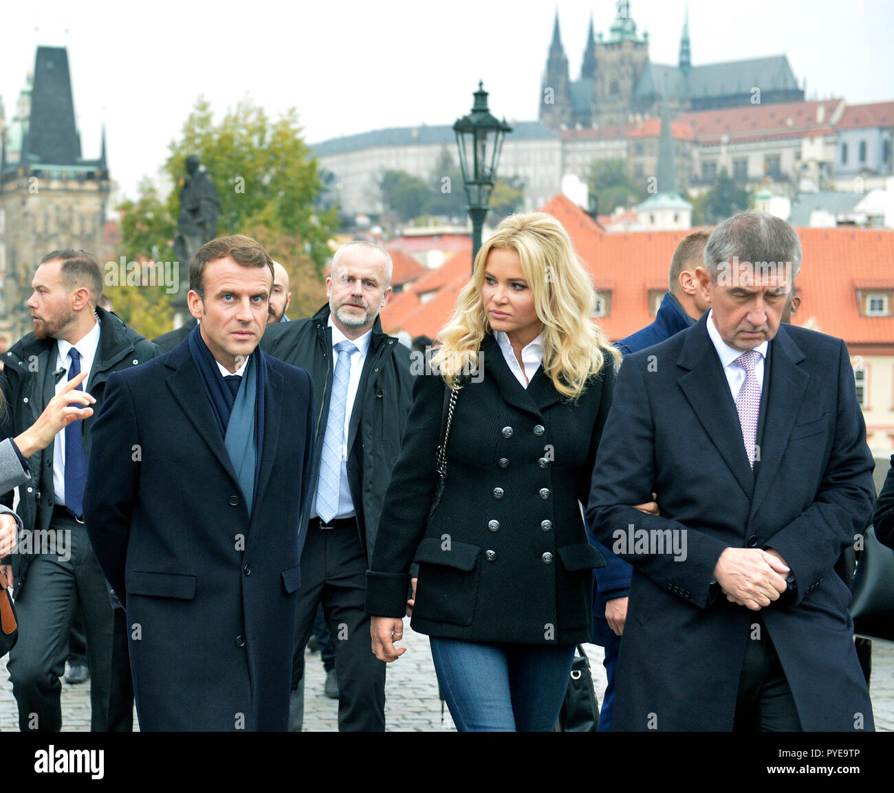 French President Emmanuel Macron (left) walks across the Charles Bridge ...