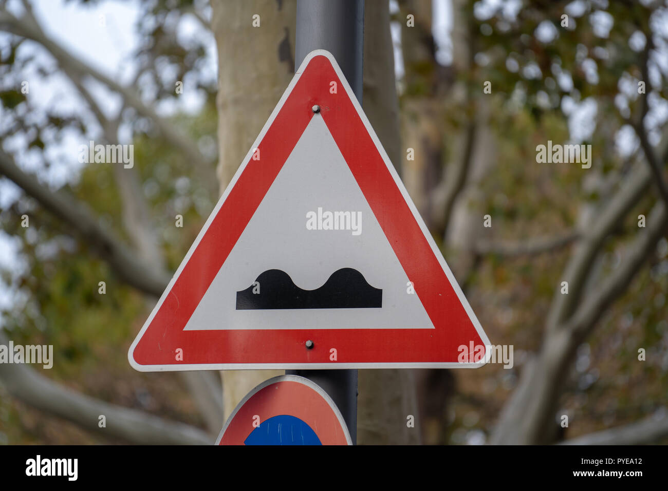 A Traffic sign in a triangle shape with red outside, inside white and a ...